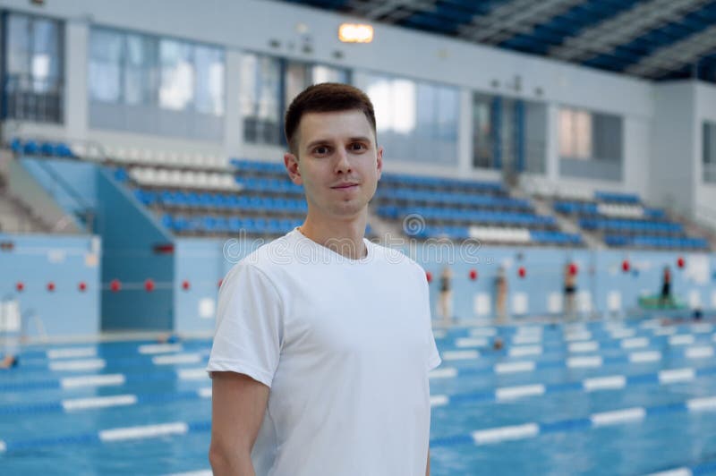 Handsome Trainer in White T-shirt Standing at the Swimming Pool Stock ...