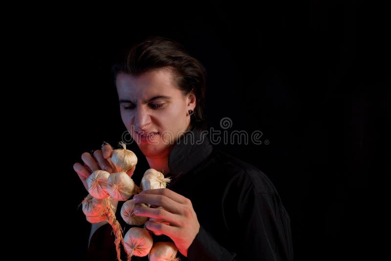 Vampire with Scary Eyes is Licking Garlic Stock Image - Image of evil ...