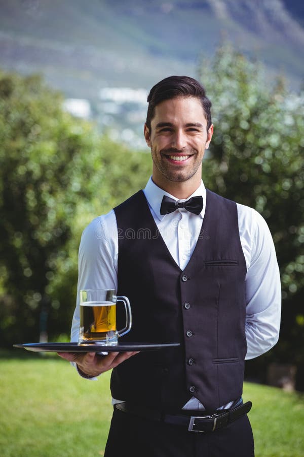Handsome Waiter Holding a Tray with a Pint of Beer Stock Image - Image ...