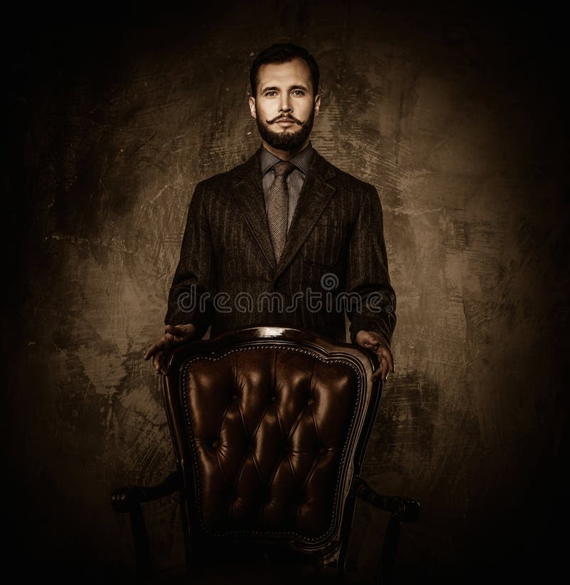 Handsome well-dressed man stock image. Image of armchair - 47003533