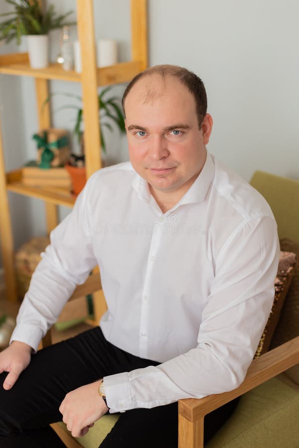 Handsome Well-groomed Man on a Couch in a Modern Interior. Stock Image ...