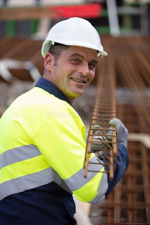 Handsome Worker Carrying Metal Rod Stock Image - Image of material ...