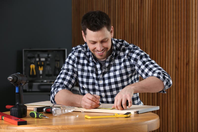 Handsome Working Man Making Marks on Timber at Table Indoors Stock ...