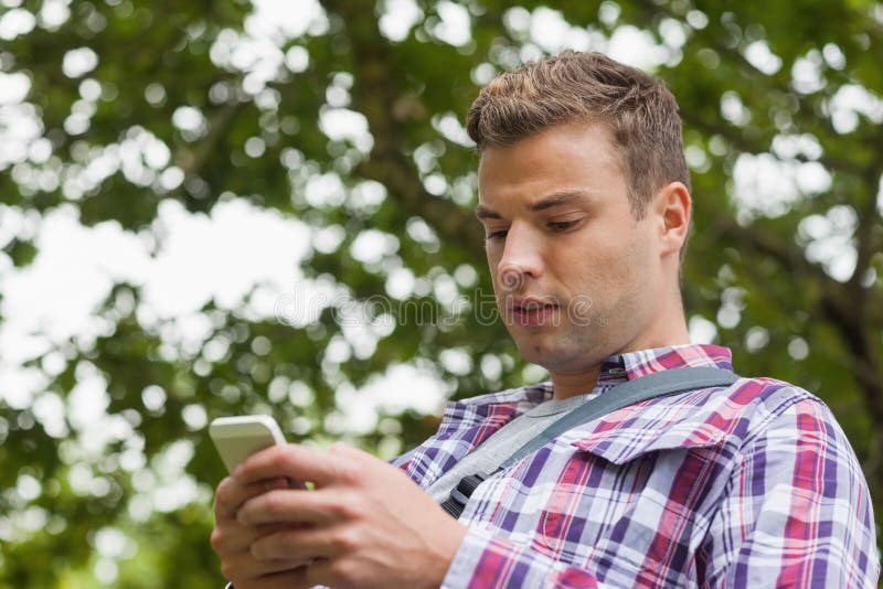 Handsome Worried Student Standing and Texting Stock Photo - Image of ...