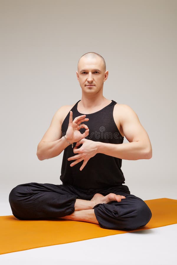 Handsome Yogi Posing at Camera while Meditating Stock Photo - Image of ...