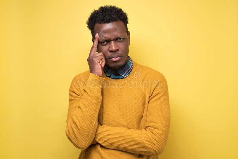 Handsome Young Afrcain Man Thinking on Yellow Background Stock Photo ...