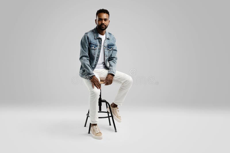 Handsome Young African American Guy Sitting on Stool, Posing in Studio ...