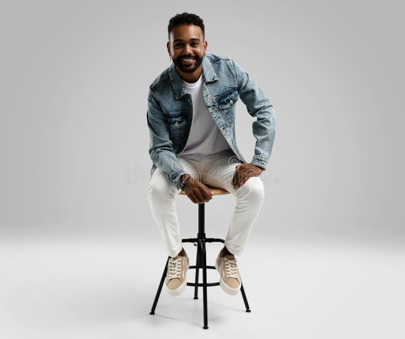 Handsome Young African American Guy Sitting on Stool, Posing in Studio ...