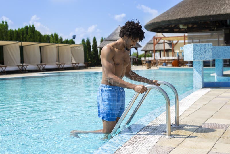Handsome Young African American Man Getting into a Pool Stock Photo ...