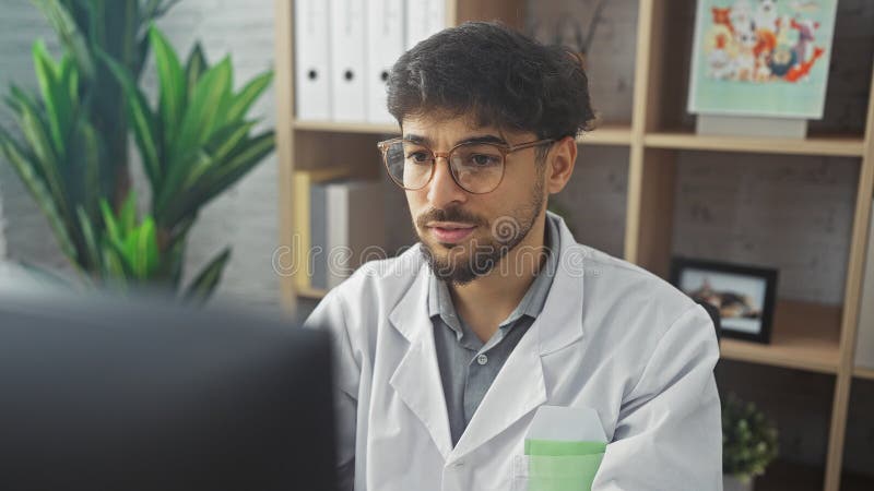 Handsome Young Arab Man in a White Lab Coat Working Inside a Hospital ...