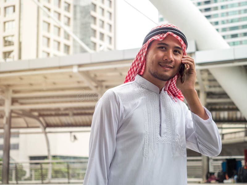 Handsome Young Arabic Male Texting on a Mobile Phone Stock Photo ...