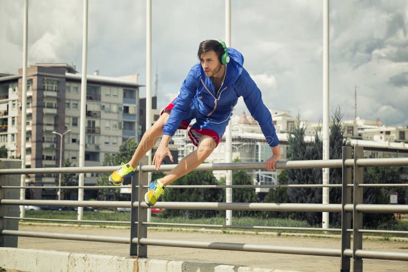Handsome Young Athlete Jumping Over the Fence Stock Image - Image of ...