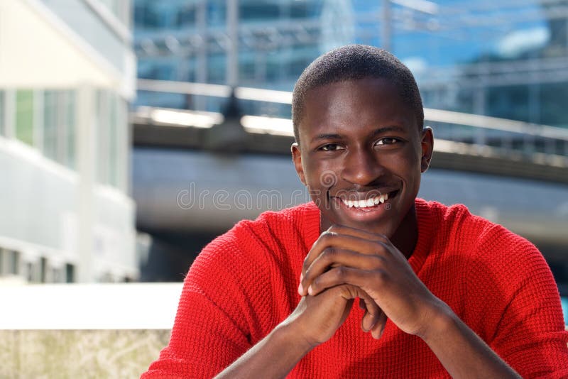 Handsome Young Black Guy Sitting Outdoors and Smiling Stock Photo ...