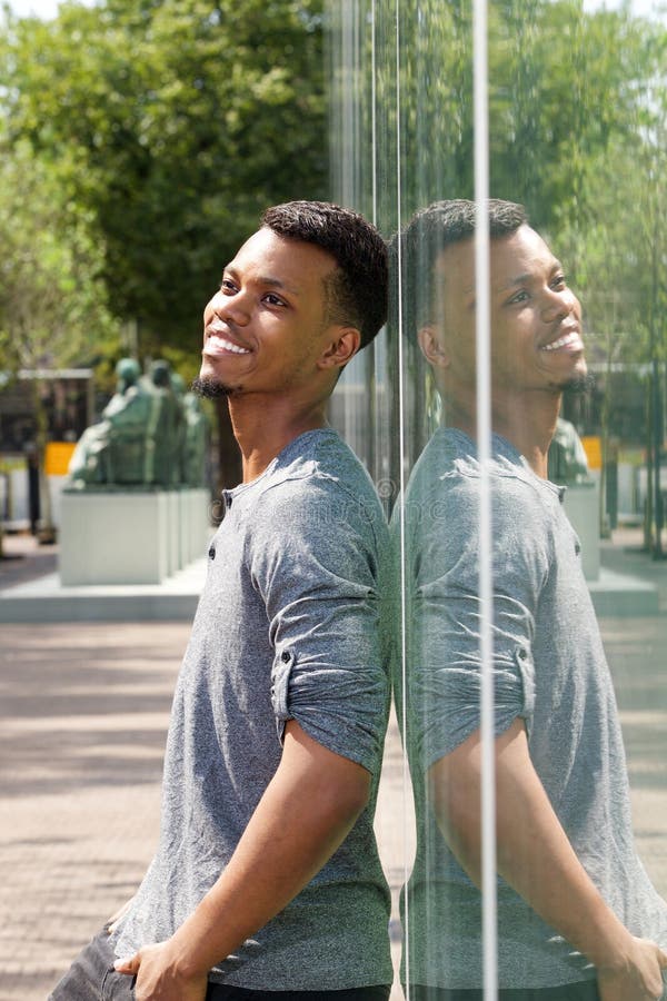 Handsome Young Black Man Leaning Against Window with Reflection Stock ...