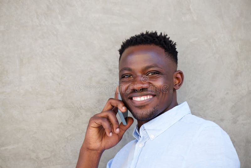 Handsome Young Black Man Making a Phone Call by Wall Stock Image ...