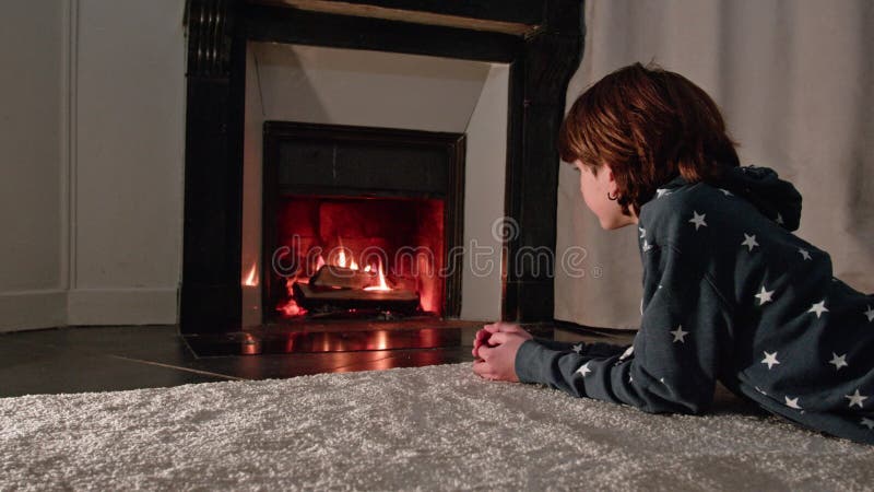 Cute Young Boy Gets Warm in Front of Fireplace at Home Stock Video ...