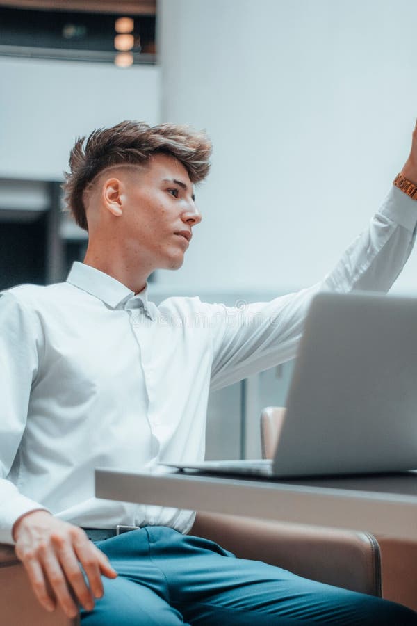 Young Business Boy Working on a Laptop in the Office Stock Photo ...