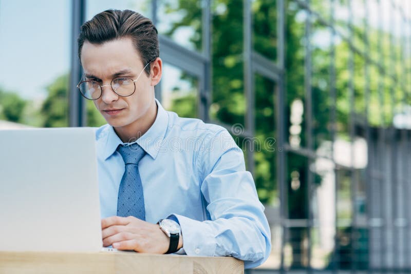 Handsome Smiling Young Man in Eyeglasses Using Laptop Outside Stock ...