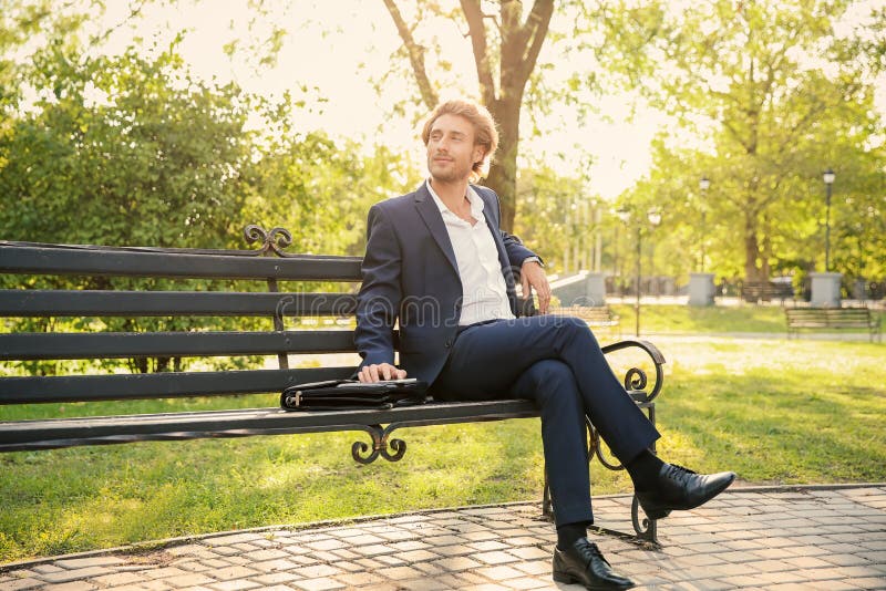 Handsome Young Businessman Resting on Bench in Park Stock Photo - Image ...