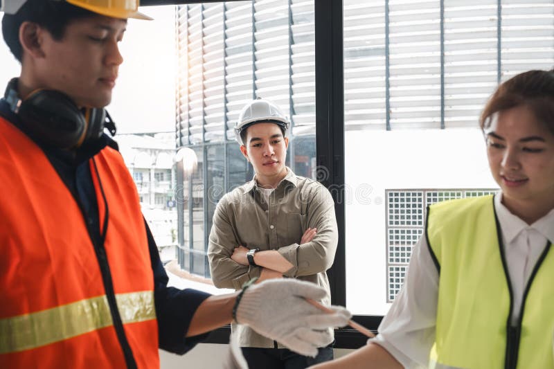 Handsome Young Chief Engineer Standing during Engineer Team Discussion ...