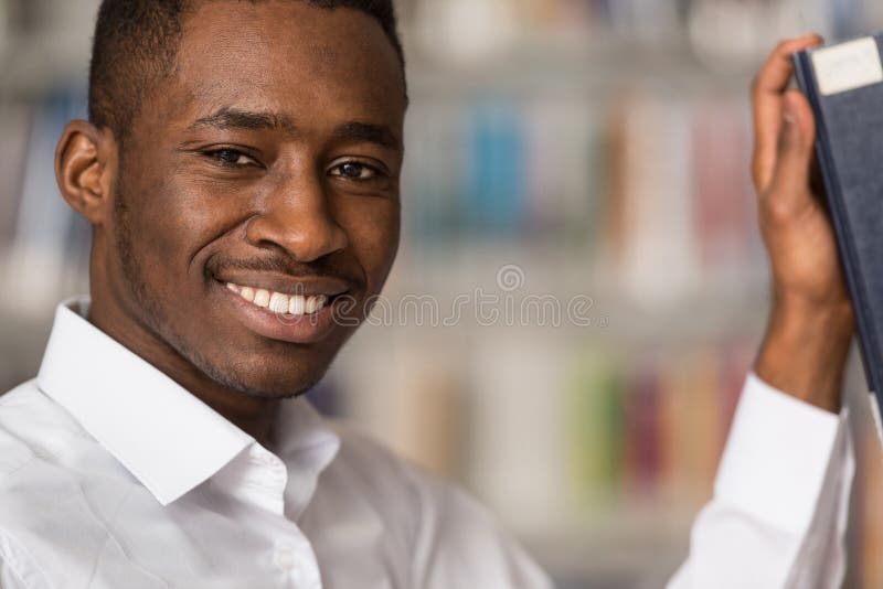 Handsome Young College Student in a Library Stock Image - Image of ...
