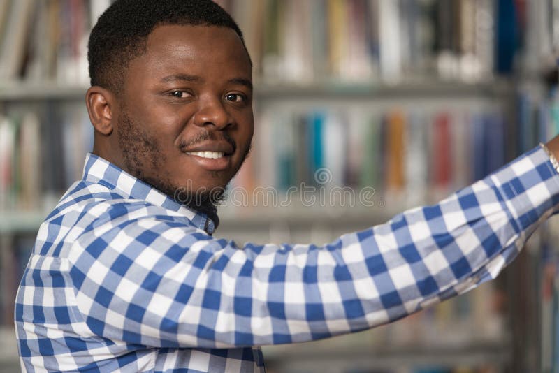 Handsome Young College Student in a Library Stock Photo - Image of ...