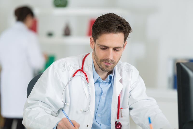 Handsome Young Doctor at Work in Office Stock Photo - Image of ...