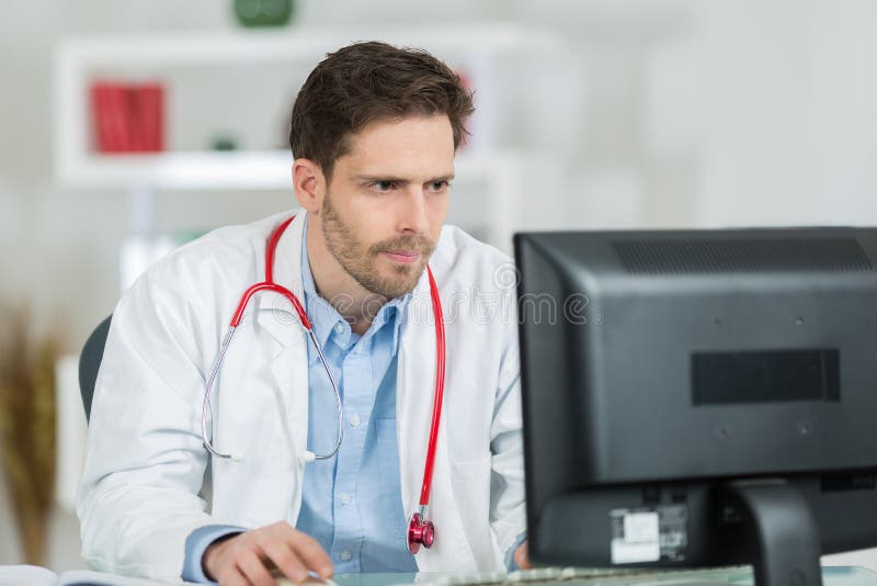 Handsome Young Doctor at Work in Office Stock Image - Image of male ...