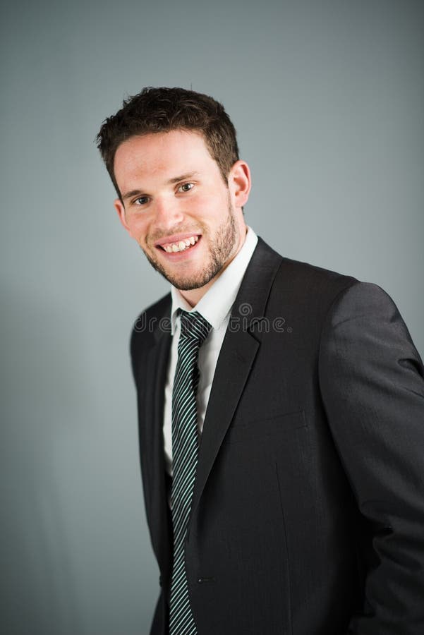Handsome Young Executive Business Man Isolated on Grey Background Stock ...