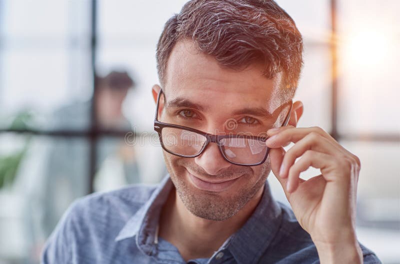 Handsome Young Guy Adjusting His Glasses in His Office Stock Image ...