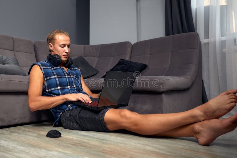 Handsome Young Guy Working with a Computer Remotely Sitting on the ...