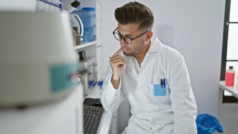 Handsome Young Hispanic Man, a Serious Scientist at Work, Thinking Hard ...