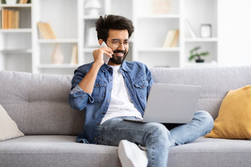 Handsome Young Indian Freelancer Guy Using Laptop and Talking on ...