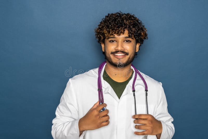 Indian Young Man Sitting on a Park Bench and Drinking Coffee while ...