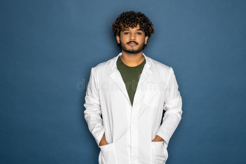 Indian Young Man Sitting on a Park Bench and Drinking Coffee while ...