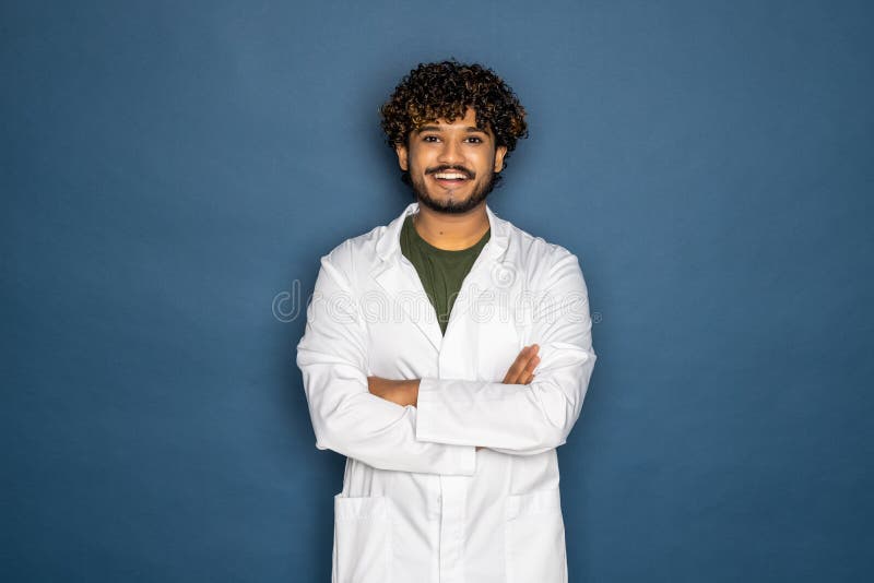 Indian Young Man Sitting on a Park Bench and Drinking Coffee while ...