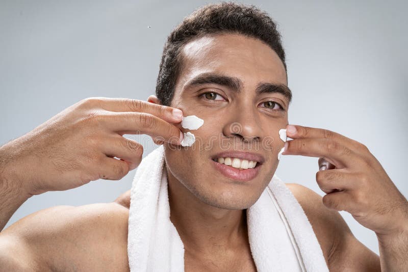 Good-looking Man Protecting His Skin with a Cream Stock Image - Image ...