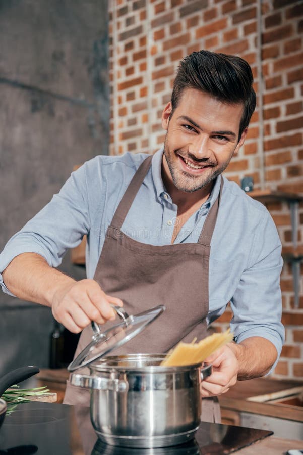 Handsome Young Man with Apron Stock Photo - Image of emotion, cookery ...