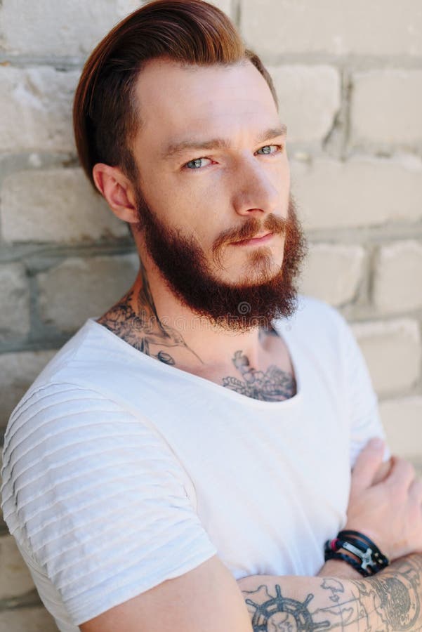 A Handsome Young Man with a Beard in a Grunge-style Interior Stock ...