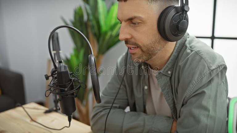 Handsome Young Man with Beard at Microphone in Radio Studio, Looking ...