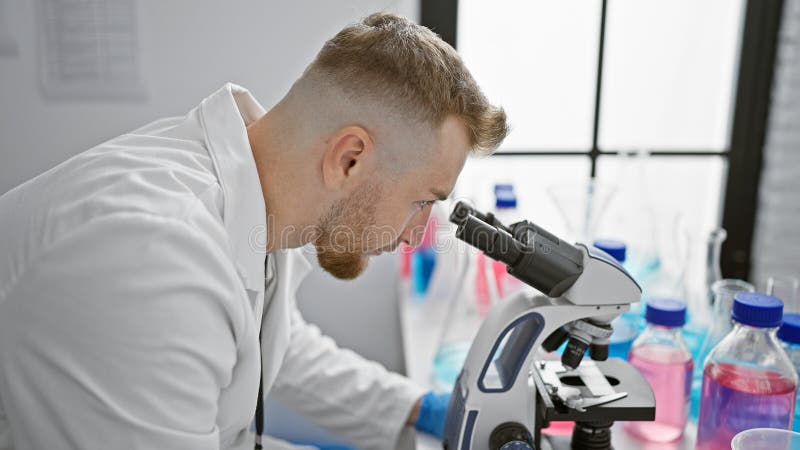 Handsome Young Man with Beard Using Microscope in Laboratory Setting ...
