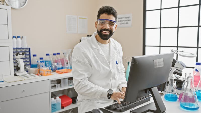 Handsome Young Man with Beard Working on Computer in Laboratory Setting ...