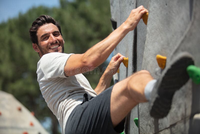 Handsome Young Man Bouldering or Rock Climbing Outdoors Stock Image ...