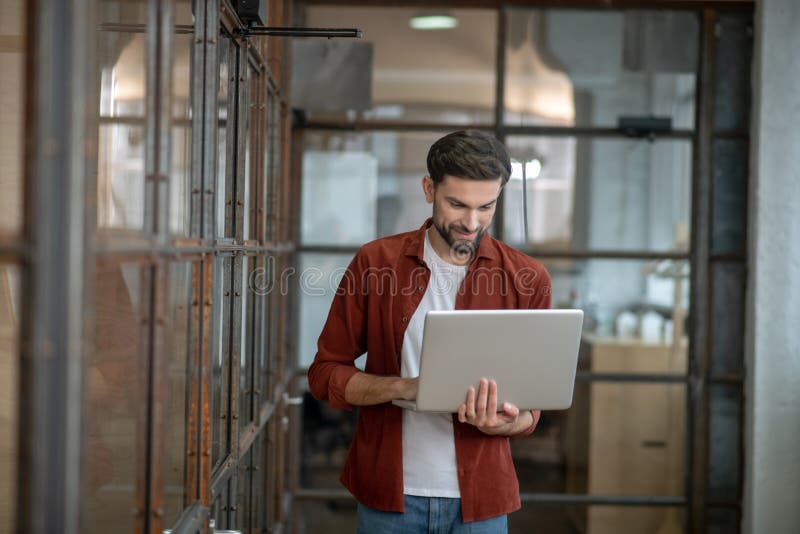 Handsome Young Man in a Brown Shirt Looking Busy Stock Photo - Image of ...