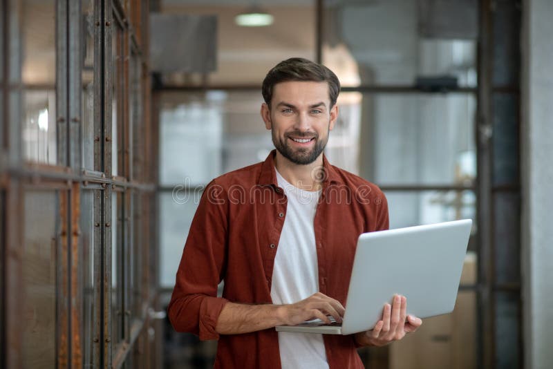 Handsome Young Man in a Brown Shirt Looking Positive Stock Image ...