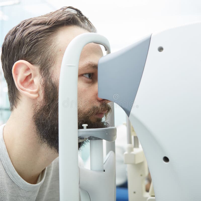 Handsome Young Man is Checking the Eye Vision in Modern Ophthalmology ...