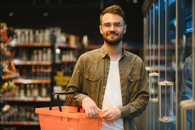 Handsome Young Man Choosing Food in the Supermarket. Stock Photo ...