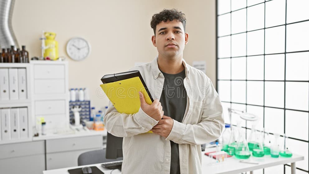 Handsome Young Man with a Clipboard in a Science Laboratory Full of ...