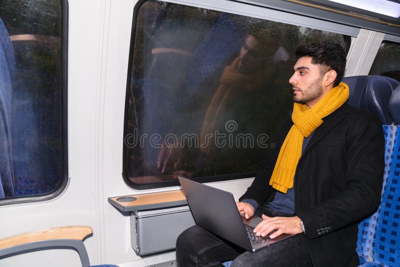 Young Man Using His Laptop Computer while on Train Stock Photo - Image ...