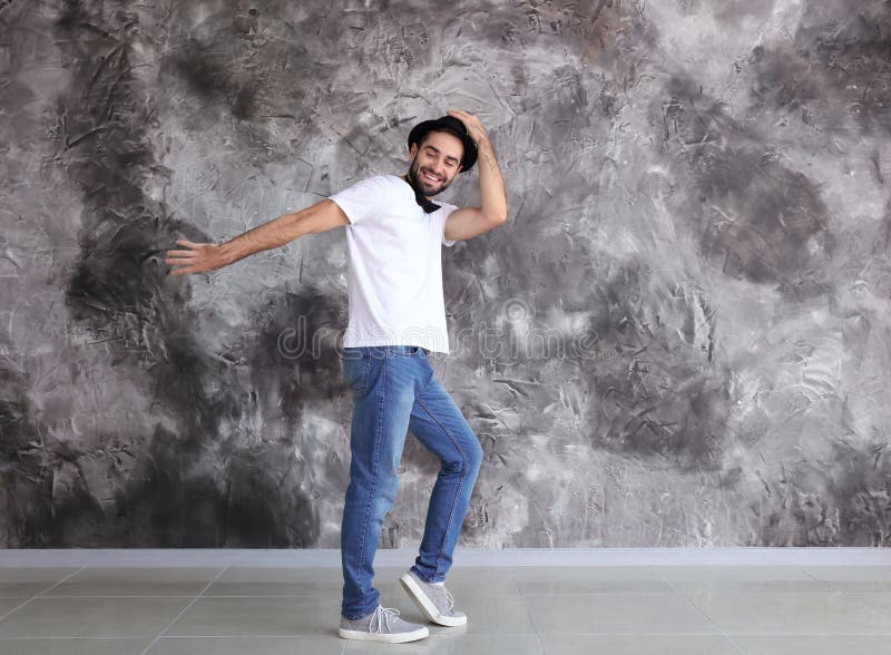 Handsome Young Man Dancing Near Grunge Wall Stock Image - Image of ...